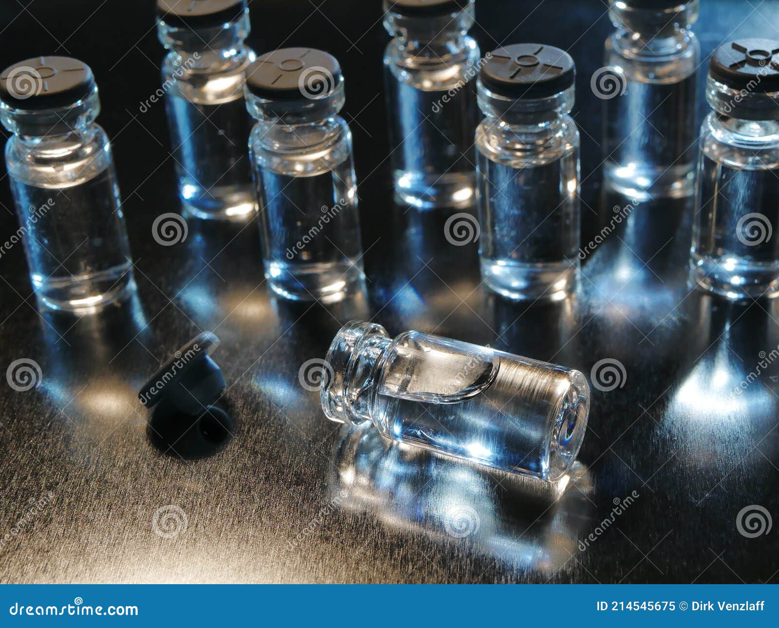 Seven Filled Vials in the Background, One Open Vial in the Foreground ...