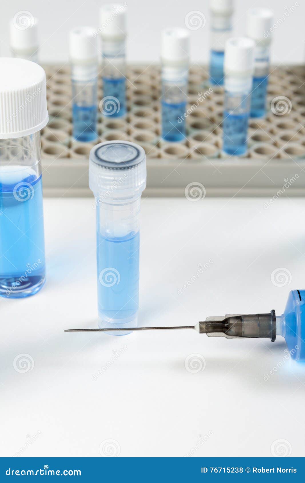 Vials of Blue Liquid and a Syringe on Bench Stock Photo - Image of ...