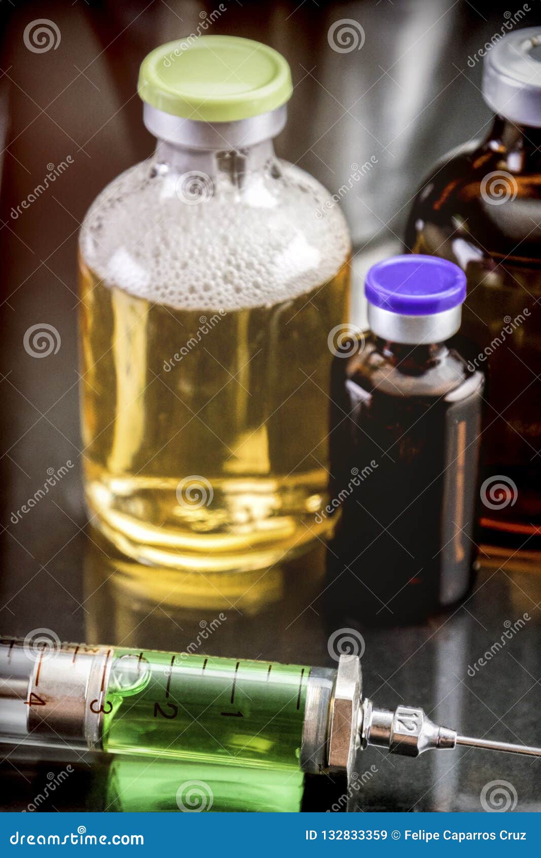 Vials of Different Size Next To Syringe of Metal in a Laboratory Stock ...