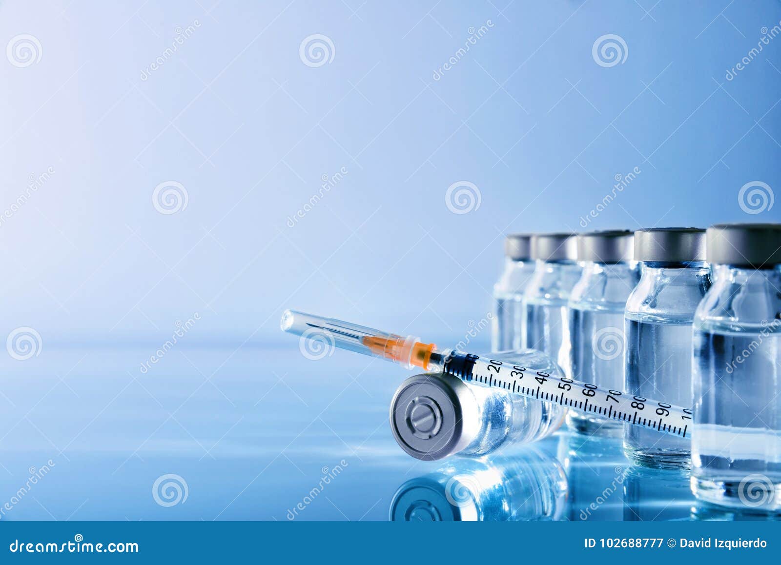 Vials Group and Syringe on Table with Blue Background Stock Image ...