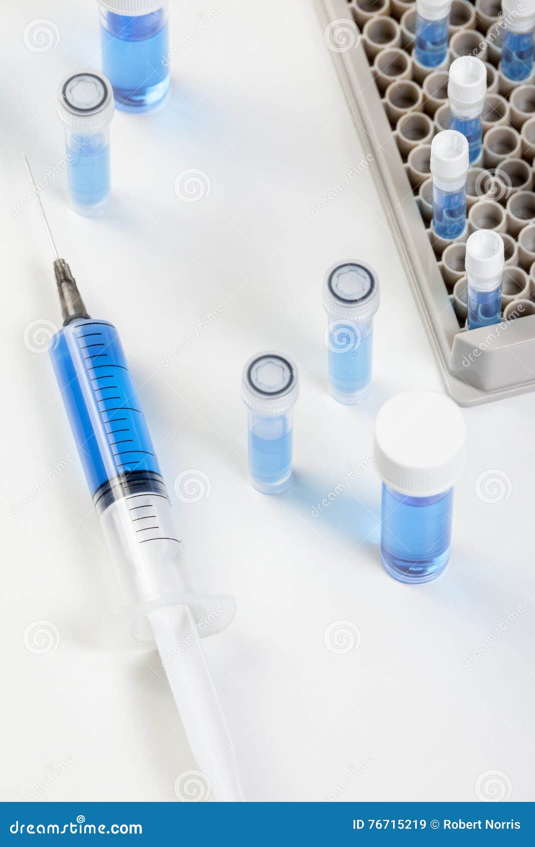 Vials in Rack and Syringe Containing Blue Liquid Stock Image - Image of ...