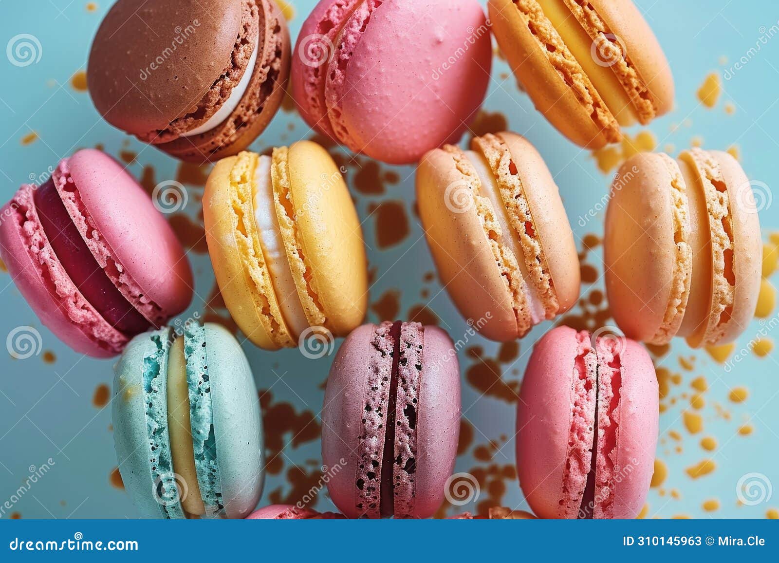 Vibrant Array of Macarons Suspended in Mid-Air Against a Cool Blue ...