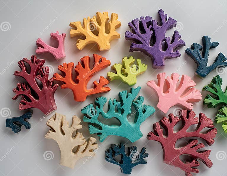 A Vibrant Array of Multi-colored Coral Pieces Arranged Against a White ...