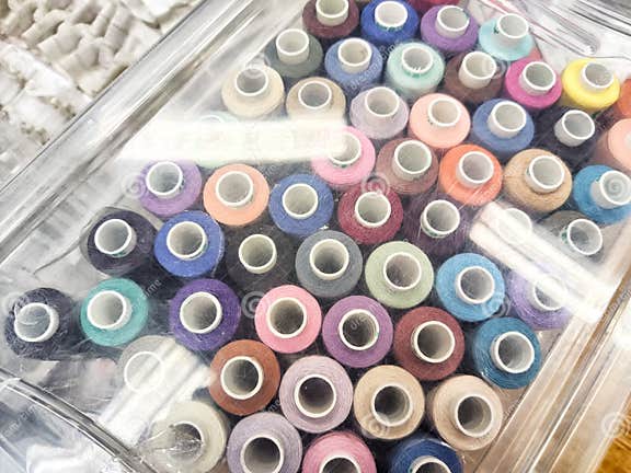 Vibrant Array of Thread Spools in a Transparent Storage Box. Colorful ...