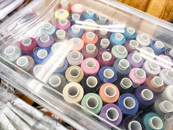 Vibrant Array of Thread Spools in a Transparent Storage Box. Colorful ...