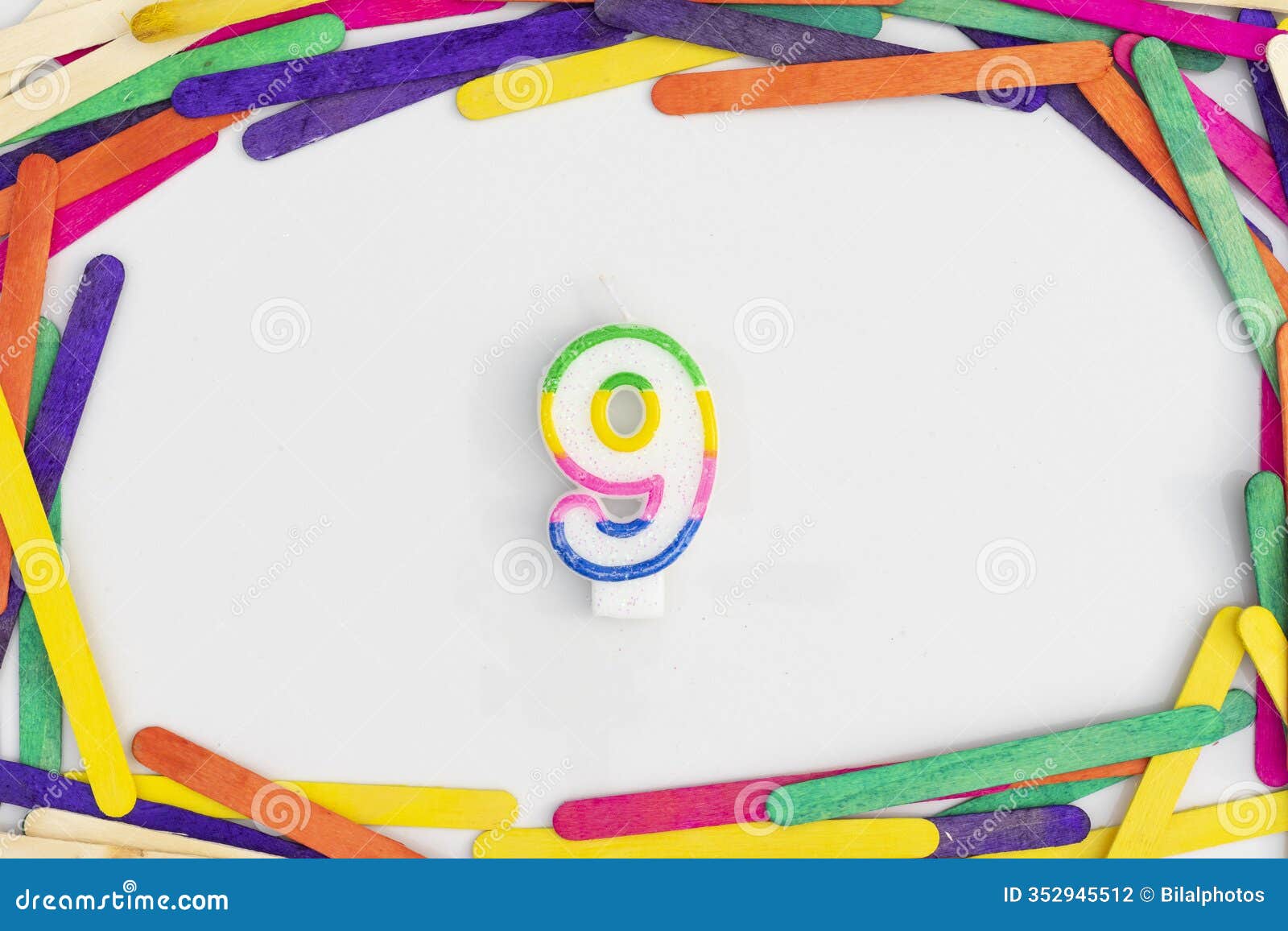 Vibrant Number Nine Candle with Popsicle Stick Border on White ...