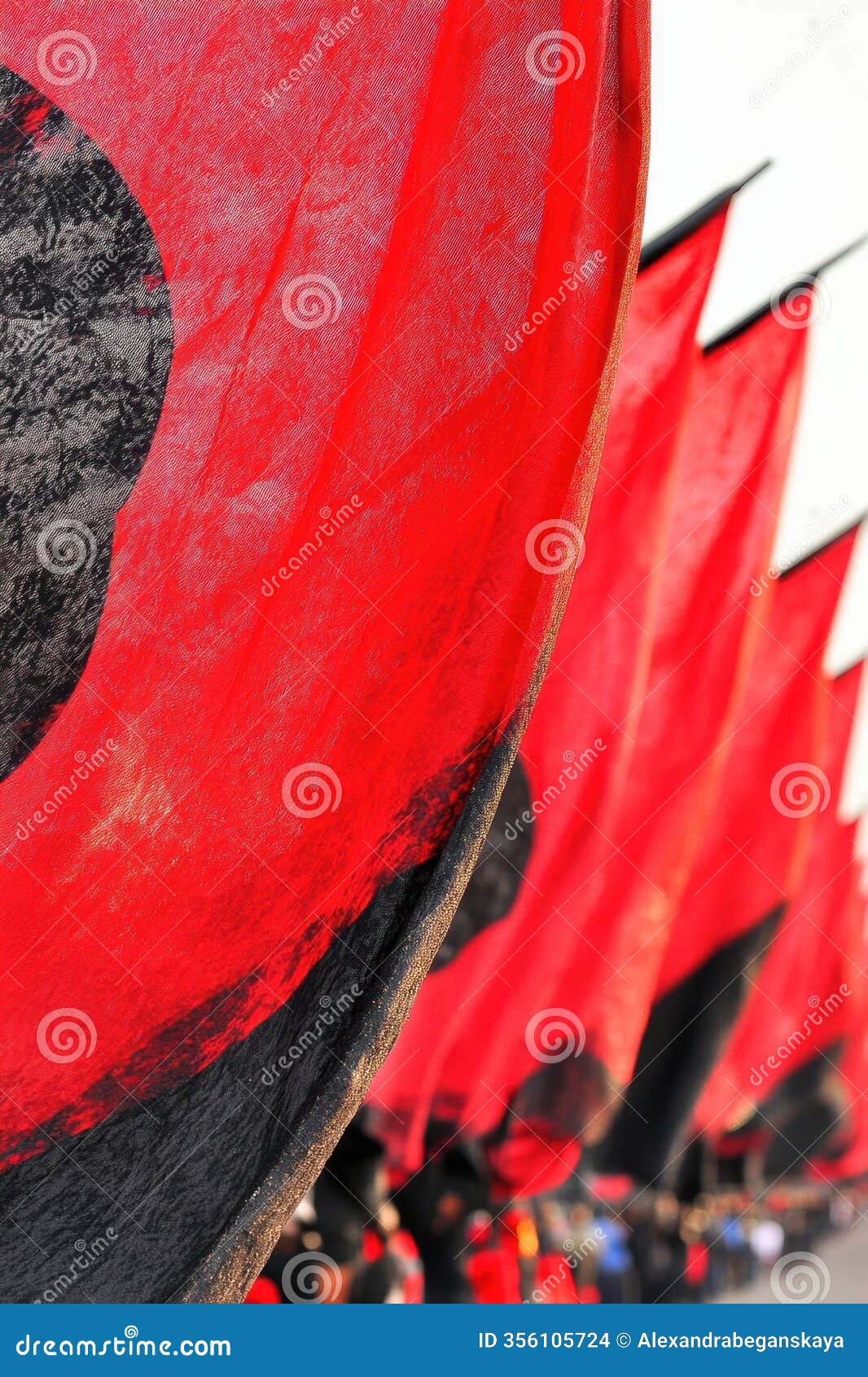 Vibrant Red Flags with Black Patterns Flapping in the Wind Stock ...