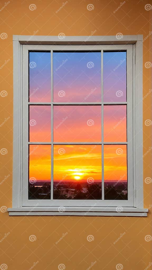 Vibrant Sunset through Window Frame with Warm Orange Sky Stock Photo ...