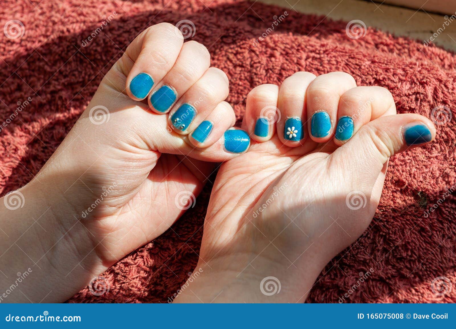 Vibrantly Painted Blue Fingernails with a Flower Stock Photo - Image of ...
