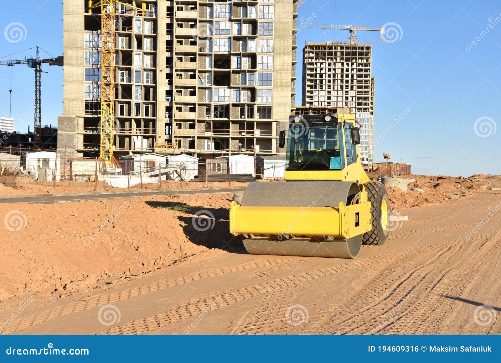 Vibro Roller Soil Compactor Leveling Ground At Construction Site. Tower ...