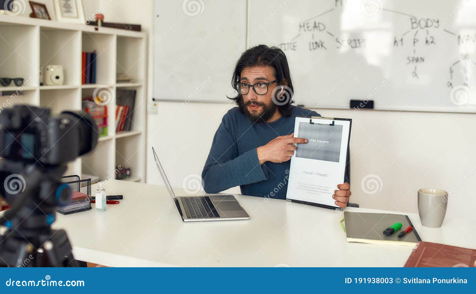 Video Blog about HTML. Young Man Wearing Eyeglasses Teaching HTML while ...