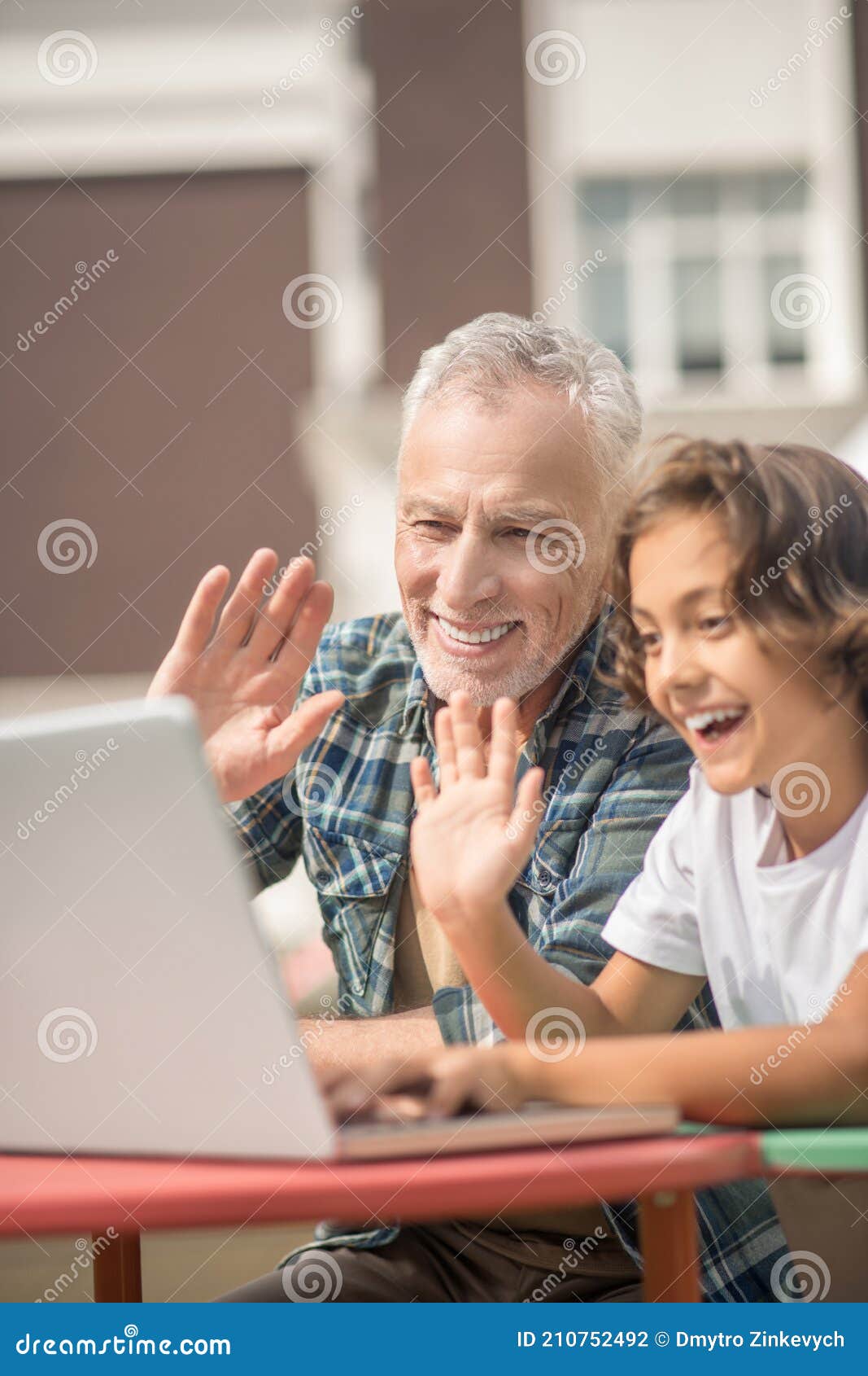 Son and Dad Sitting Together with a Laptop and Having a Video Call ...