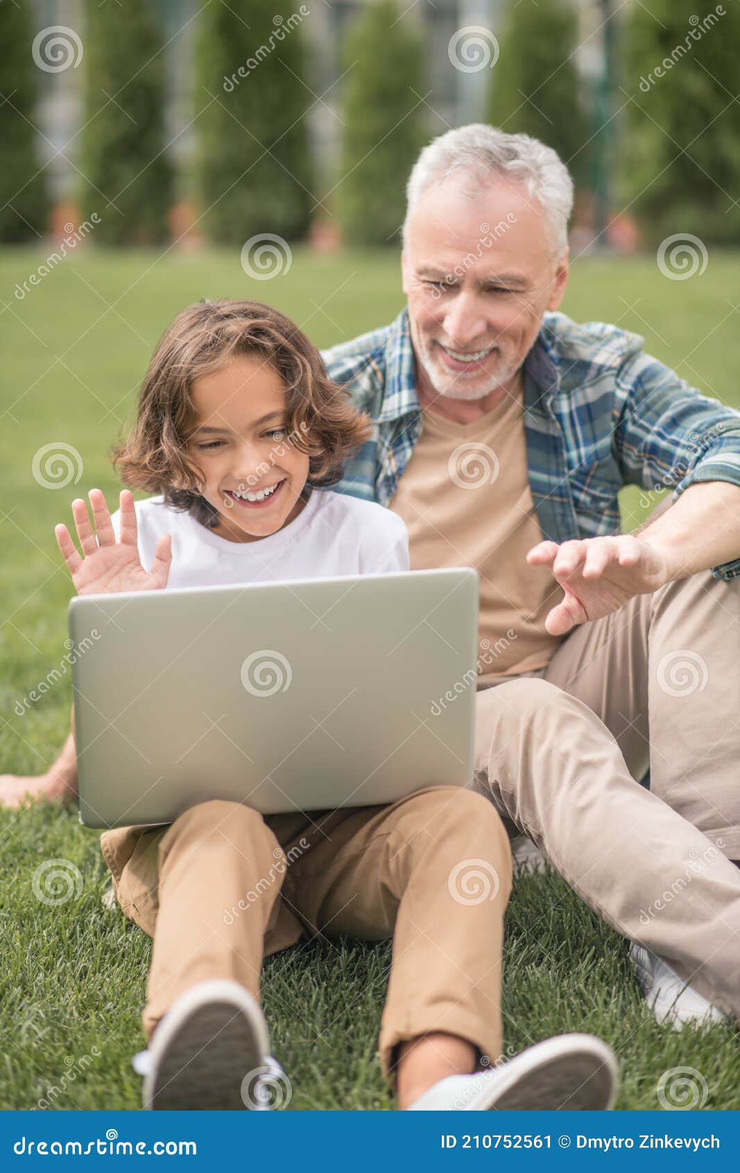 Son and Dad Sitting Together with a Laptop and Having a Video Call ...
