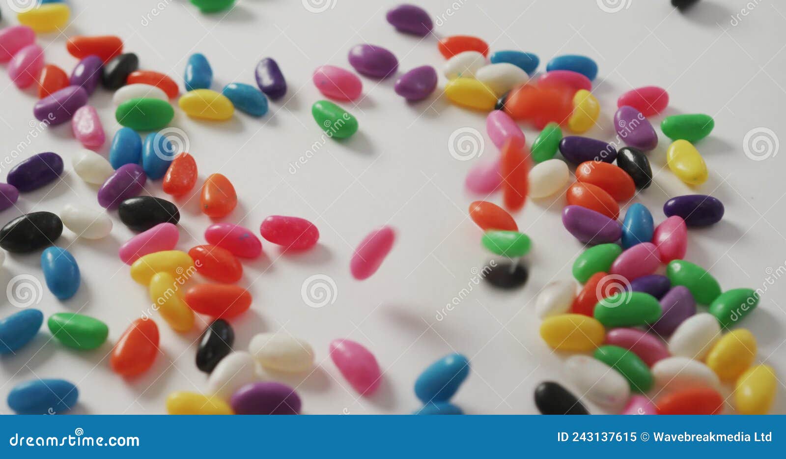 Video of Close Up of Multi Coloured Sweets Falling Over White ...