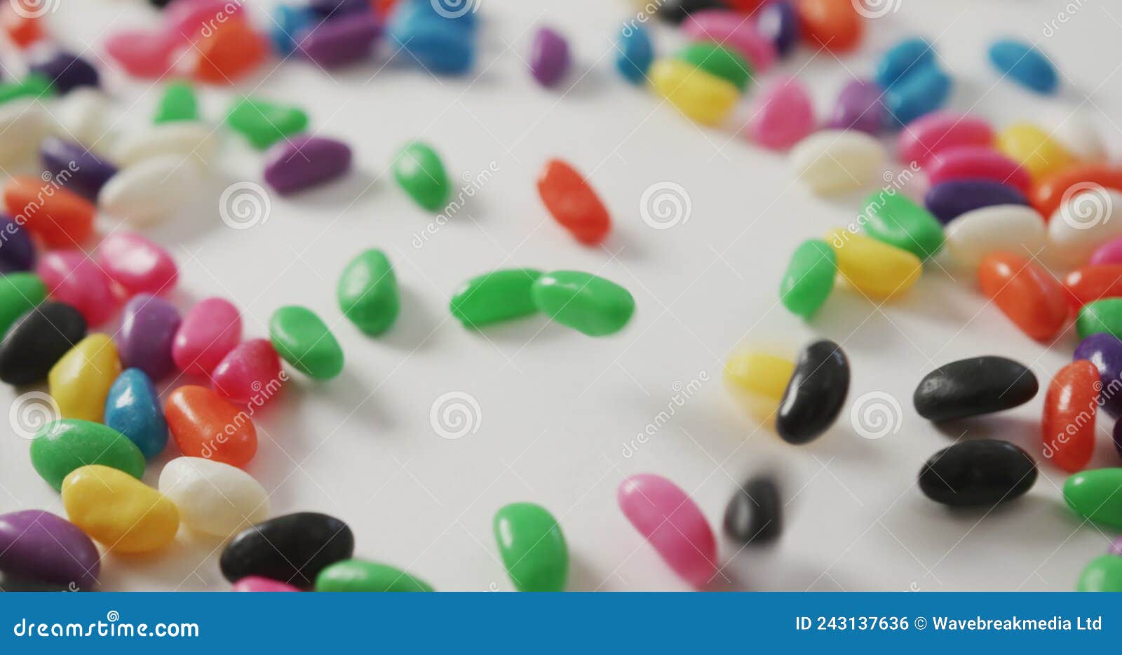 Video of Close Up of Multi Coloured Sweets Falling Over White ...