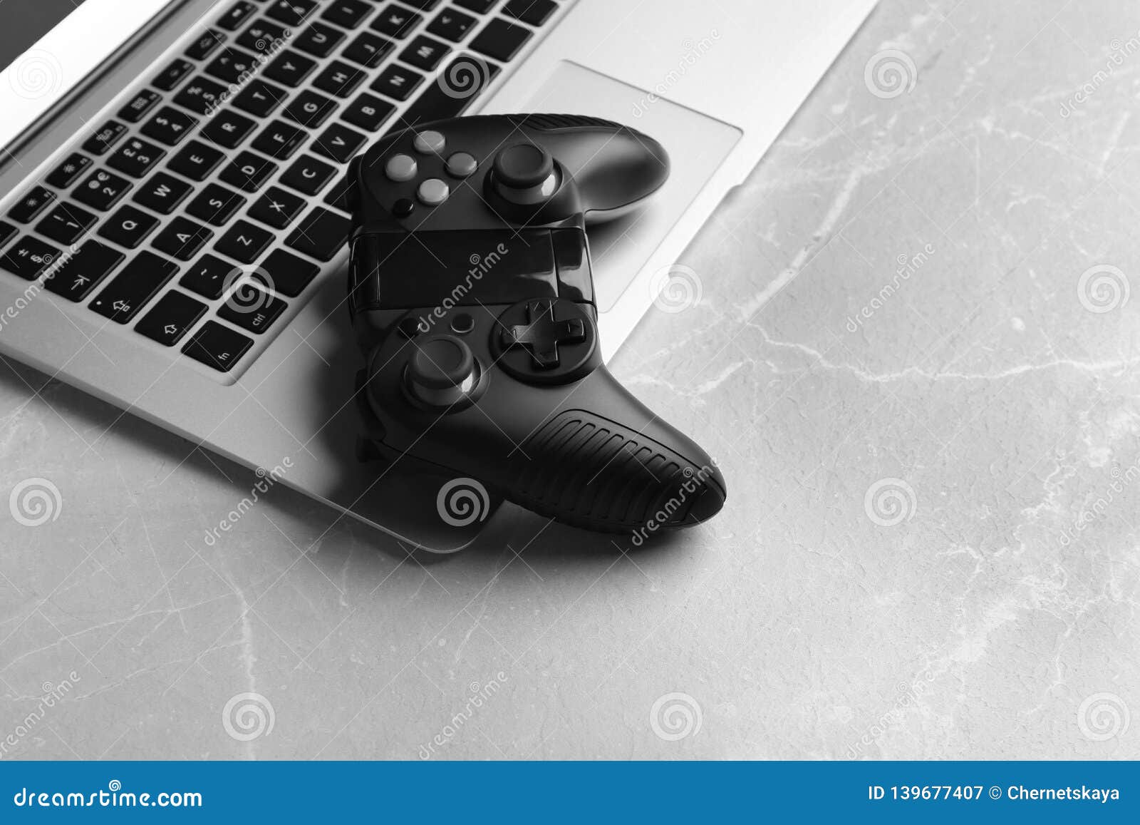 Video Game Controller and Laptop on Grey Table. Stock Image - Image of ...