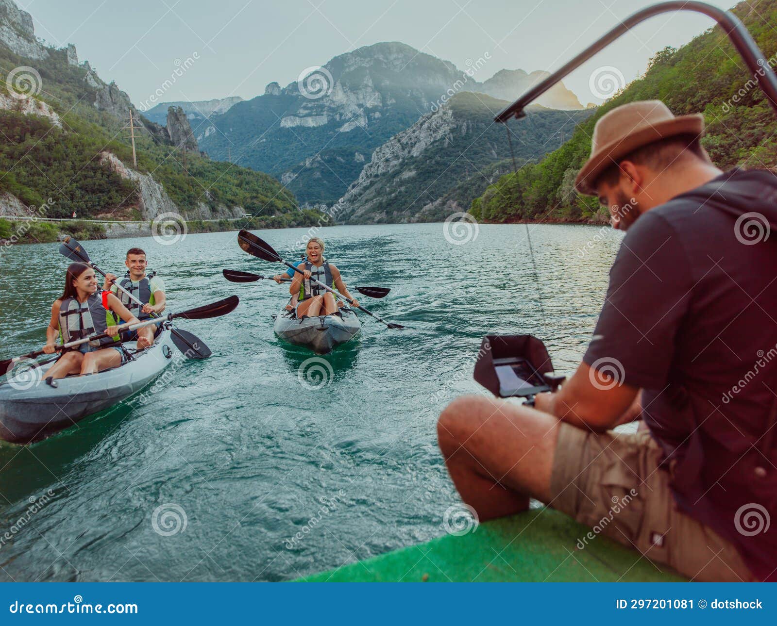 A Videographer Recording a Group of Friends Kayaking Together and ...