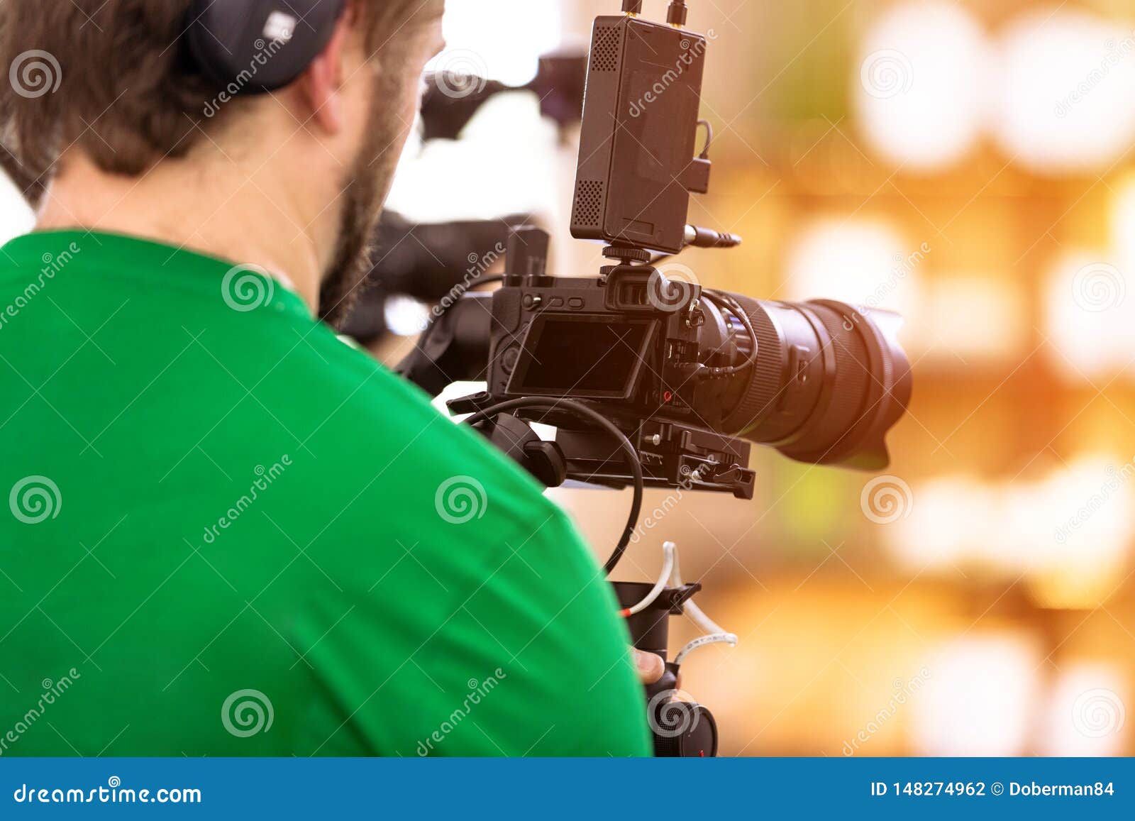 Videographer Shooting a Film or a Television Program in a Studio with a ...