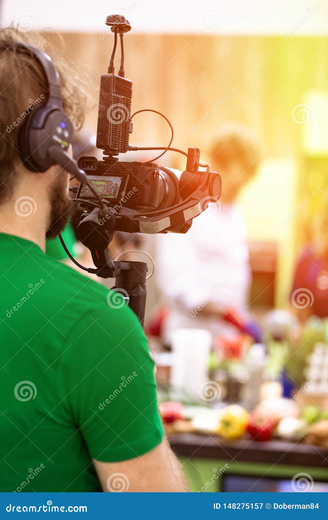 Videographer Shooting a Film or a Television Program in a Studio with a ...