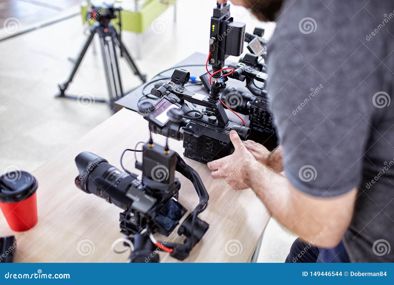 Videographer Shooting a Film or a Television Program in a Studio with a ...