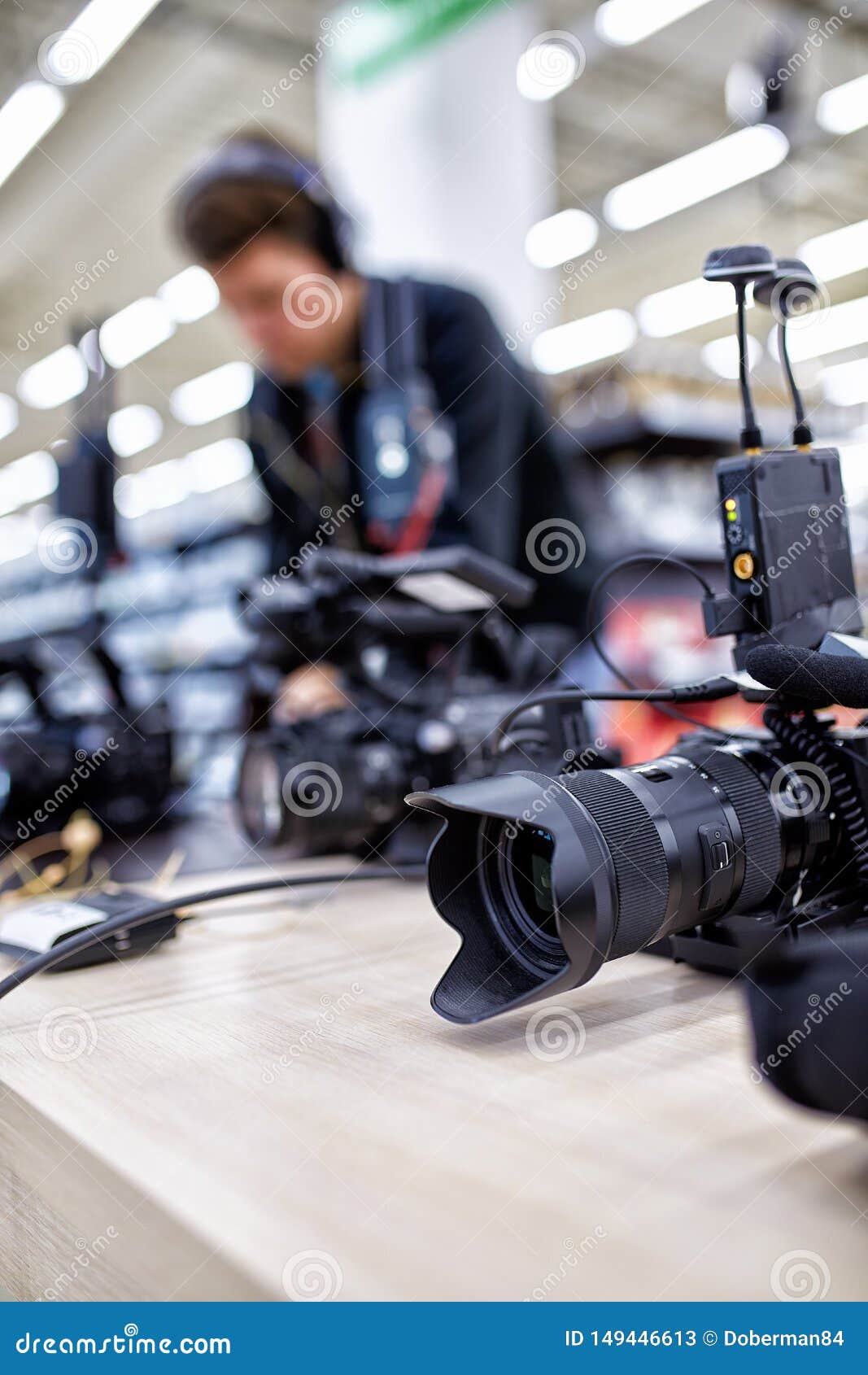 Videographer Shooting a Film or a Television Program in a Studio with a ...
