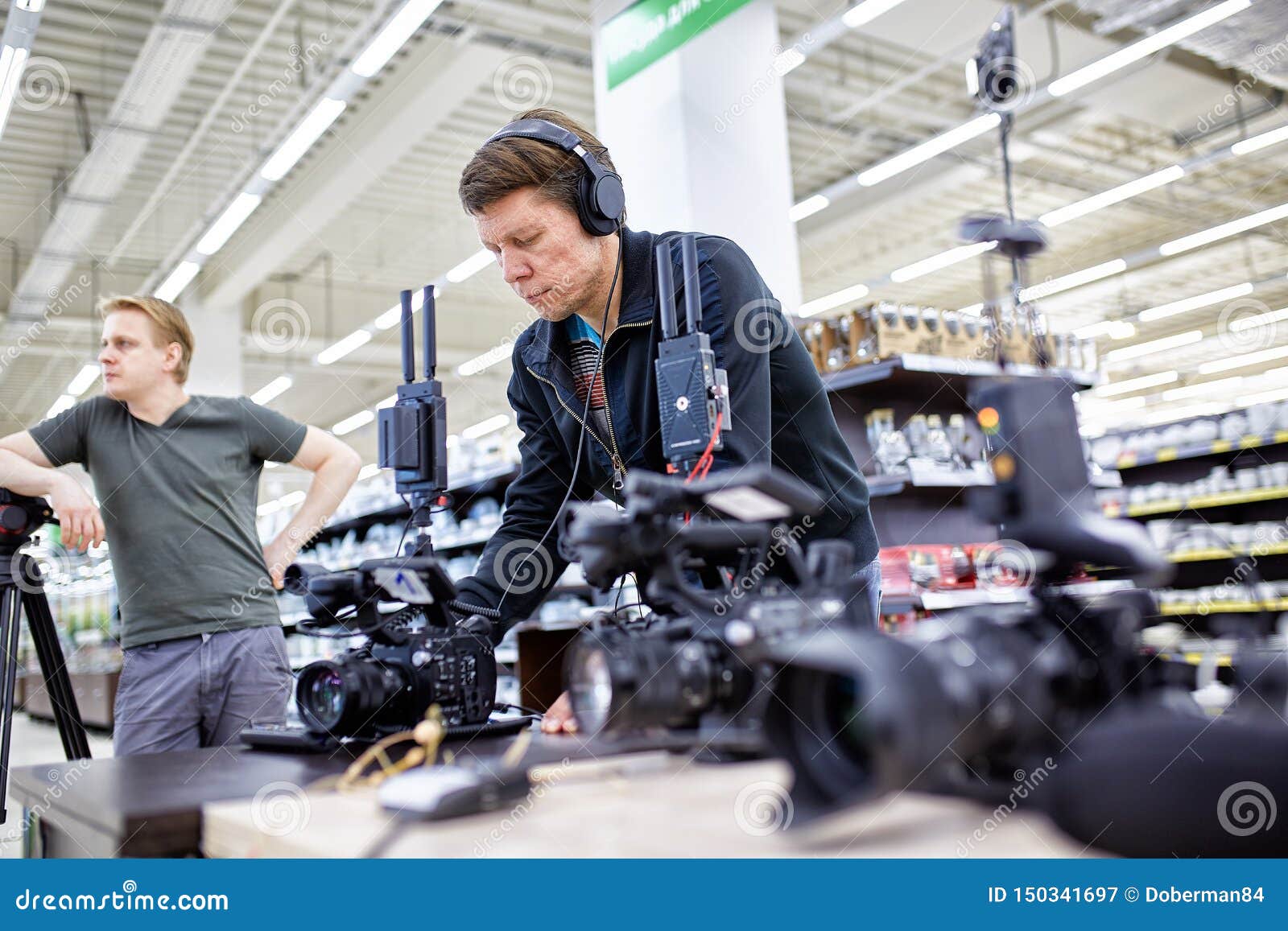 Videographer Shooting a Film or a Television Program in a Studio with a ...