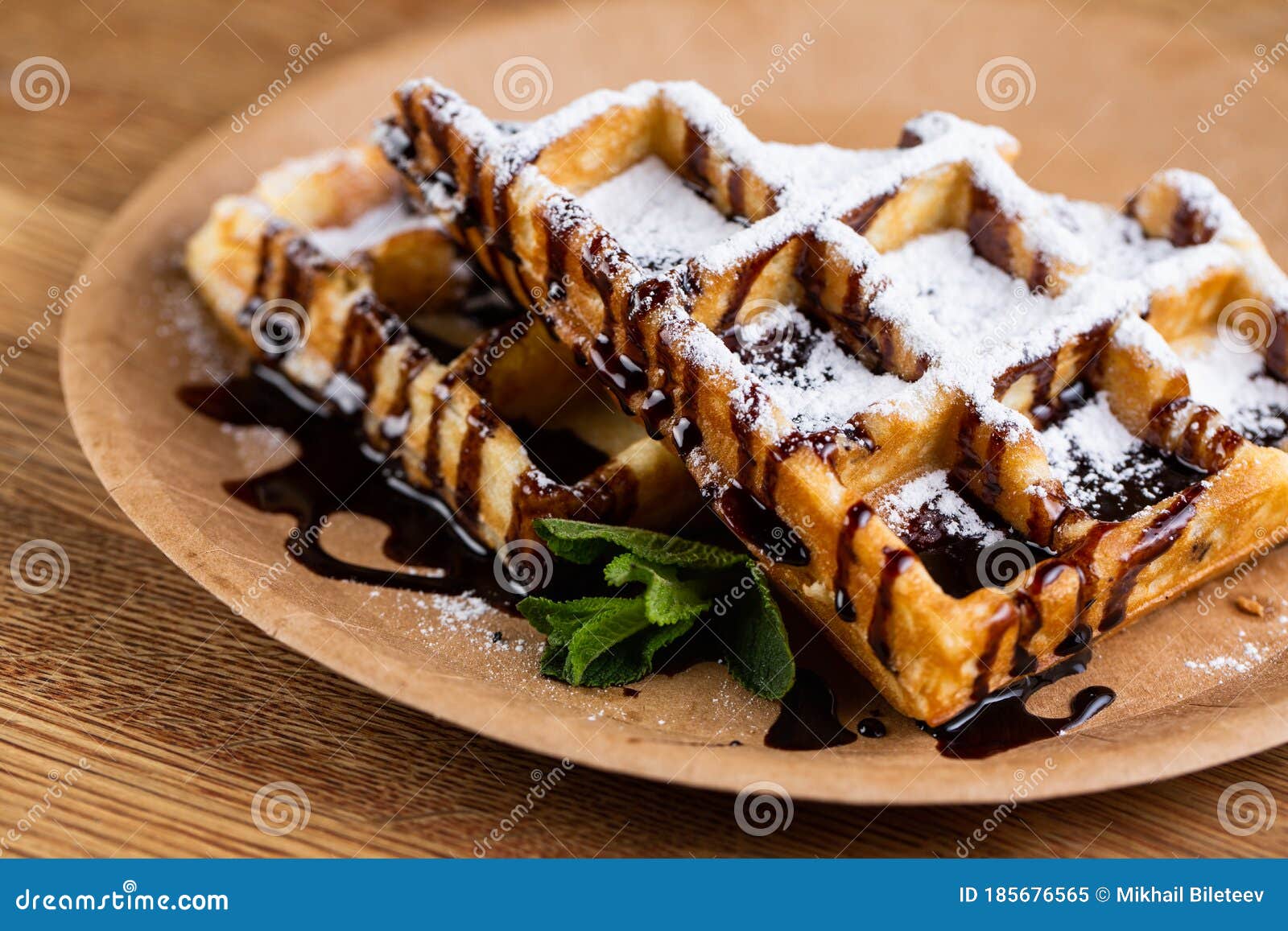 .Viennese Waffles on a Disposable Plate with Liquid Chocolate, Icing ...