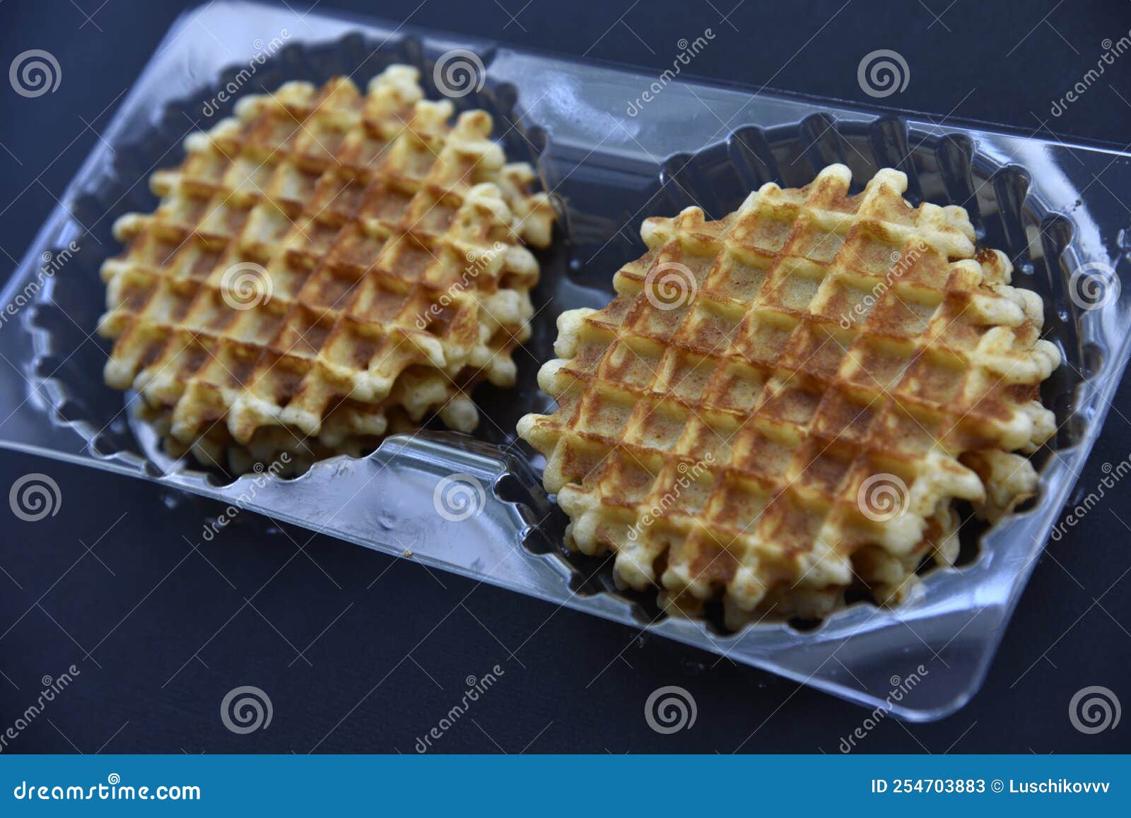 Viennese Waffles in Plastic Packaging on a Black Background. Delicious ...