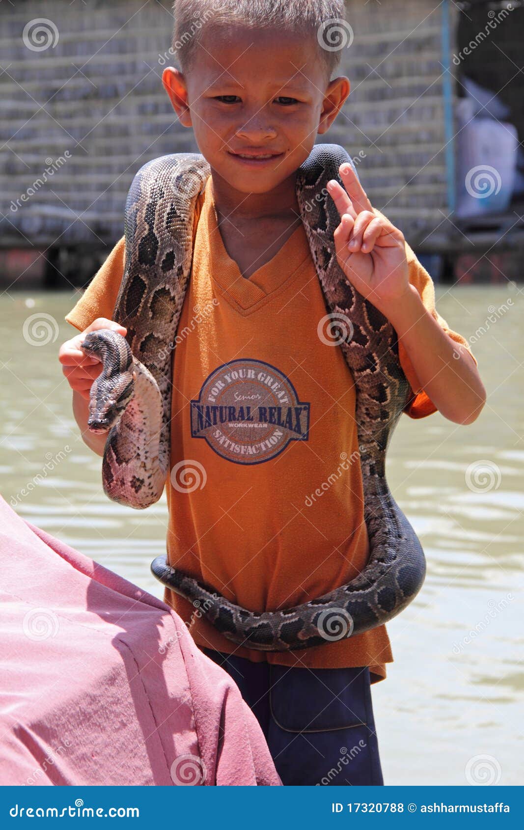 A Boy Holding A Snake Editorial Photo | CartoonDealer.com #179516221