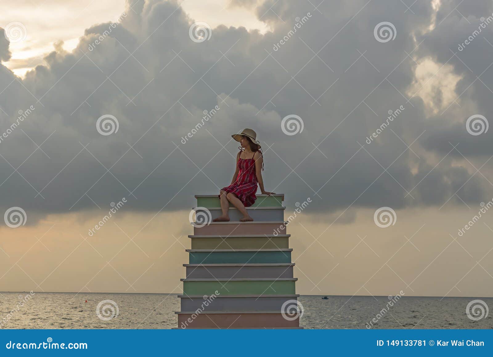 A Vietnamese Lady Sitting on Multicolored Step Structure at a Beach ...