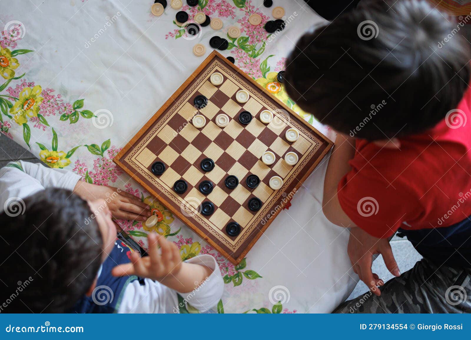View from Above of a Checkers Game Board and Two Children Playing ...