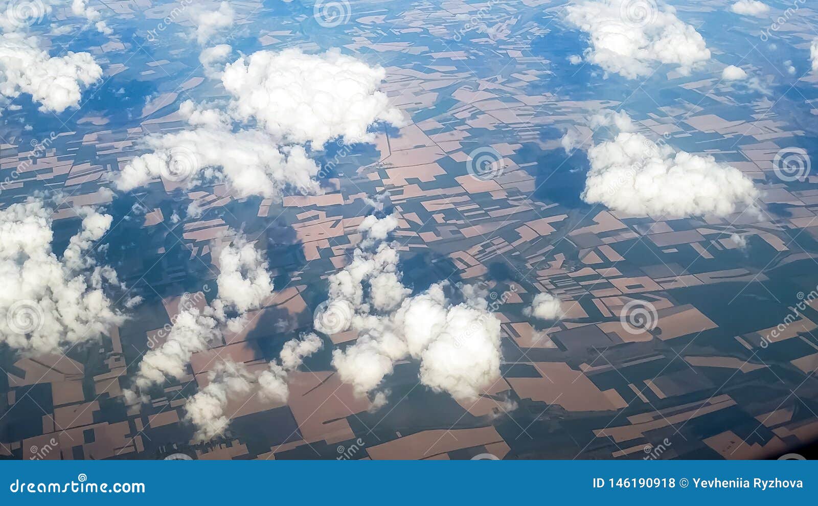 View Above the Clouds on Ground Divided by Fields Stock Photo - Image ...