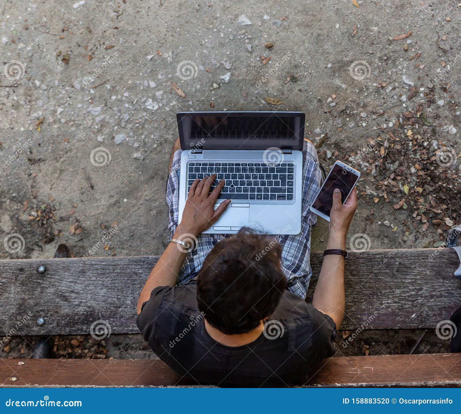 View from Above of a Digital Nomad Using His Computer and His Mobile ...