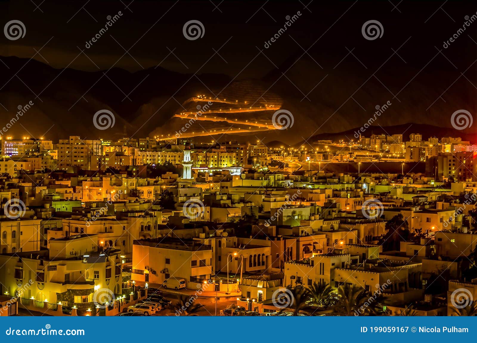 A View Across the Rooftops Towards the Distant Mountains at Night in ...
