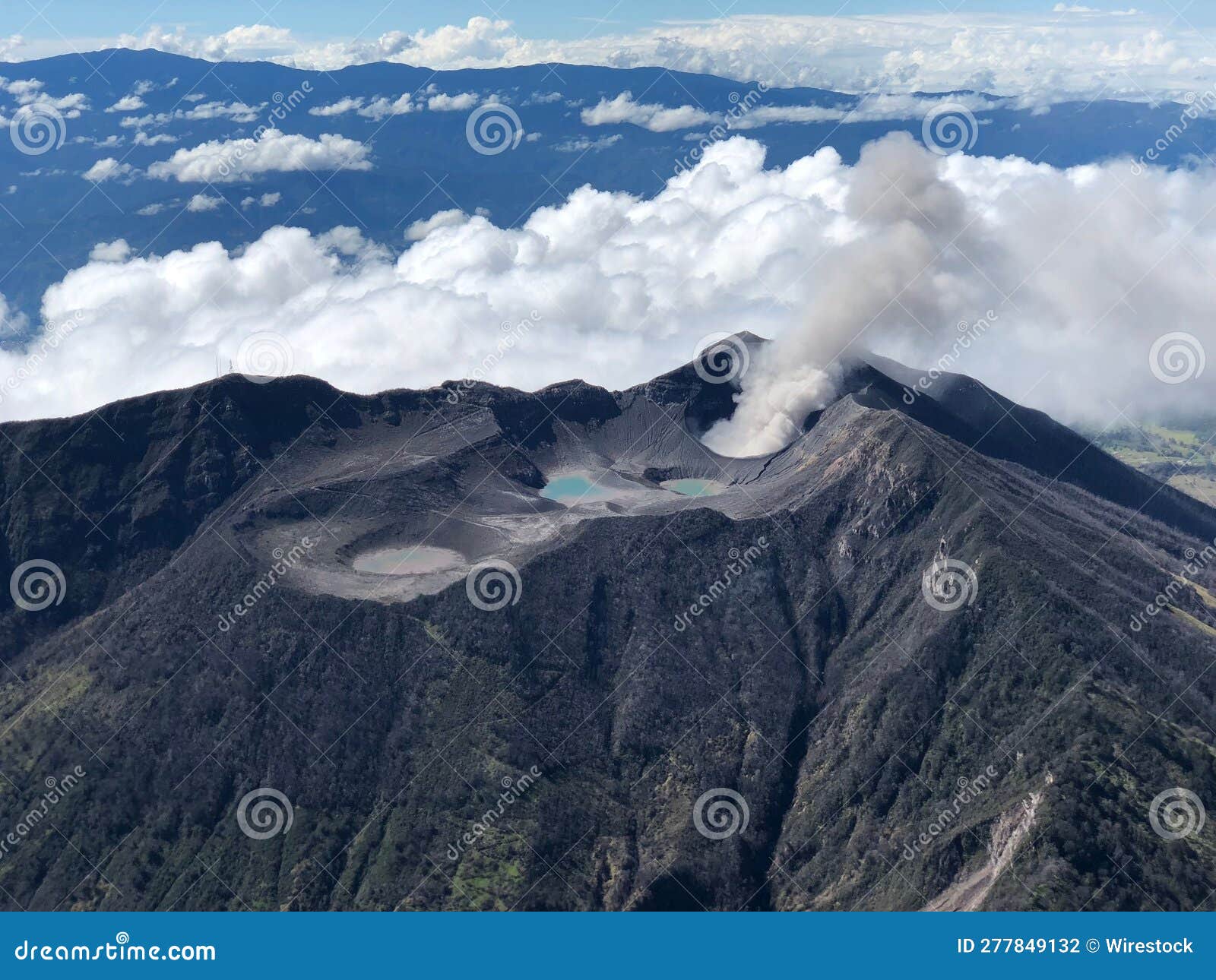 View of an Active Volcano with Billowing Clouds in the Background Stock ...