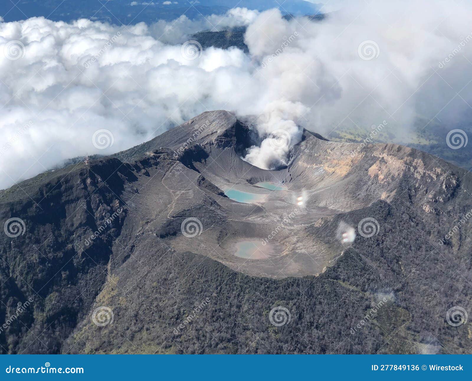 View of an Active Volcano with Billowing Clouds in the Background Stock ...