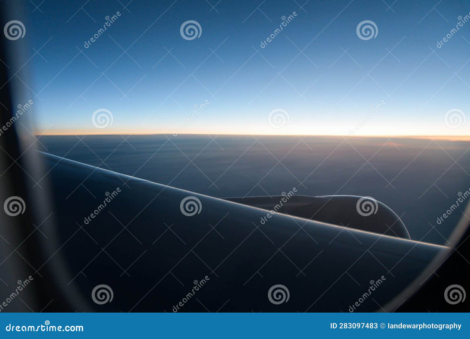 View through Aircraft Window at Empty Horizon at Dawn on Clear Morning ...
