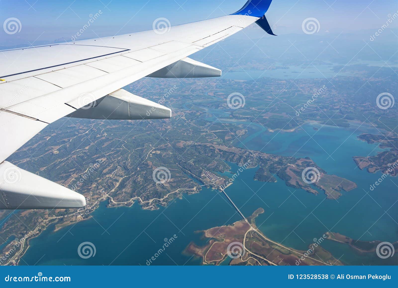 View from the Airplane Window. Clouds and Landscape Under the Wing ...