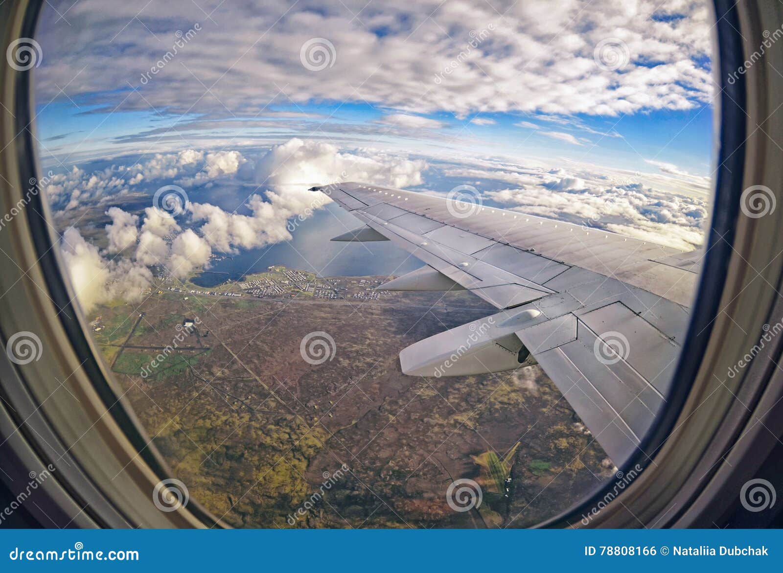 View from Airplane Window on Green Fields and Clouds Stock Photo ...