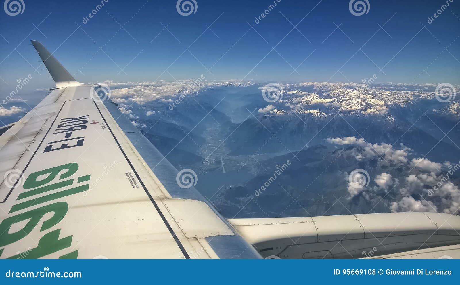 View from Airplane Window of Mountains with Snow on the Top, Clouds ...