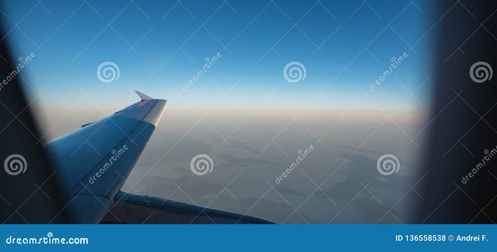 View of Airplane Wing through Window. Flying Above the Earth Stock ...