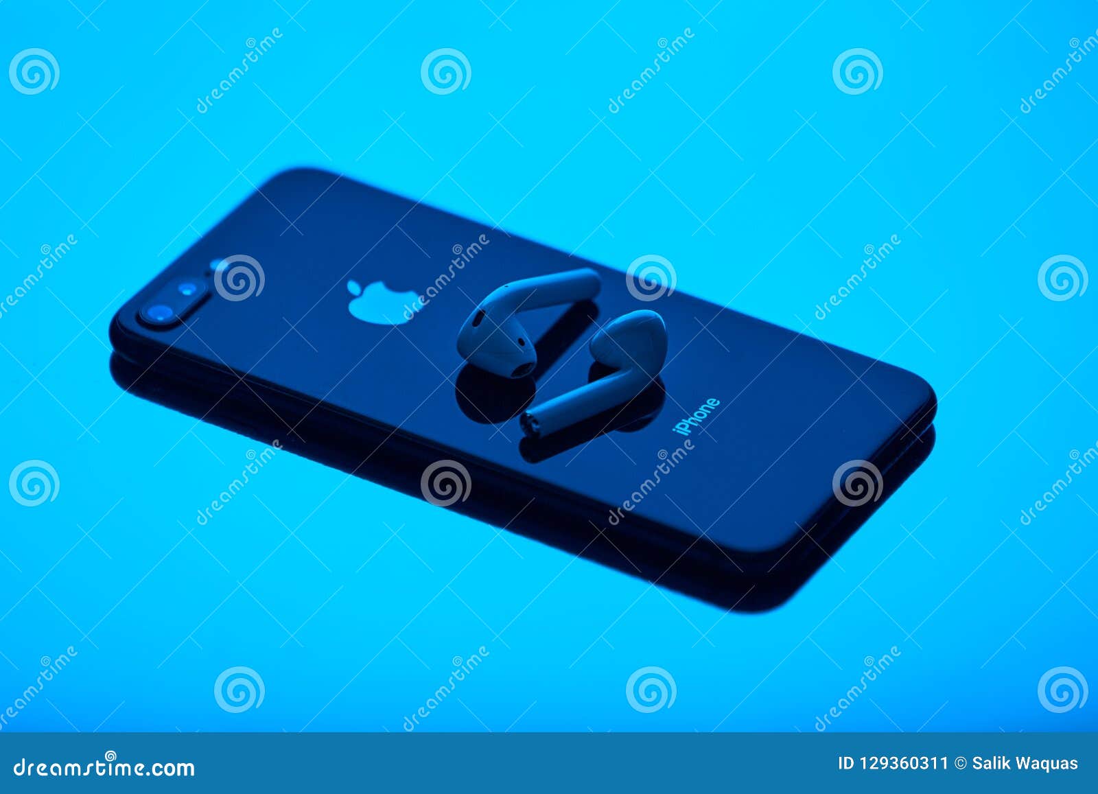 View of AirPods Wireless Bluetooth Headphones on the Table with Iphone ...