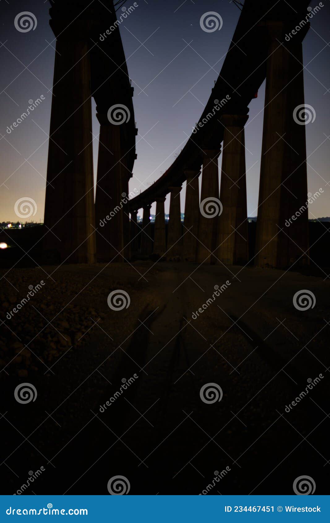 View of an Architectural Structure with Rocky Columns at Night with ...