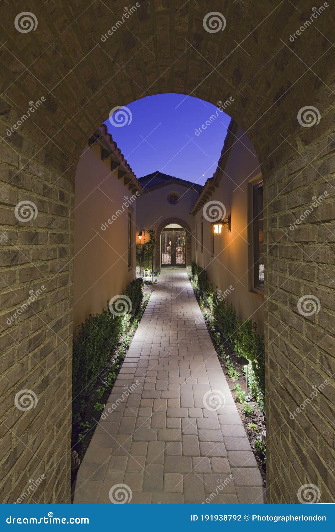 View through Archway Down Path To French Doors at Dusk Stock Photo ...