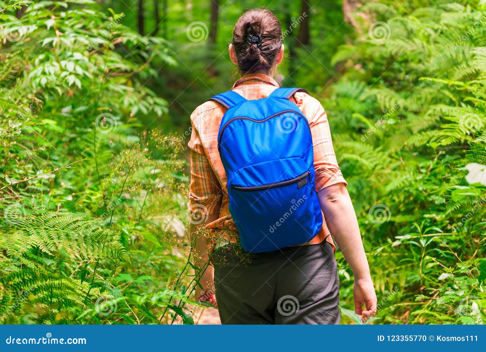 View from the Back of a Woman with a Backpack Walking through Th Stock ...