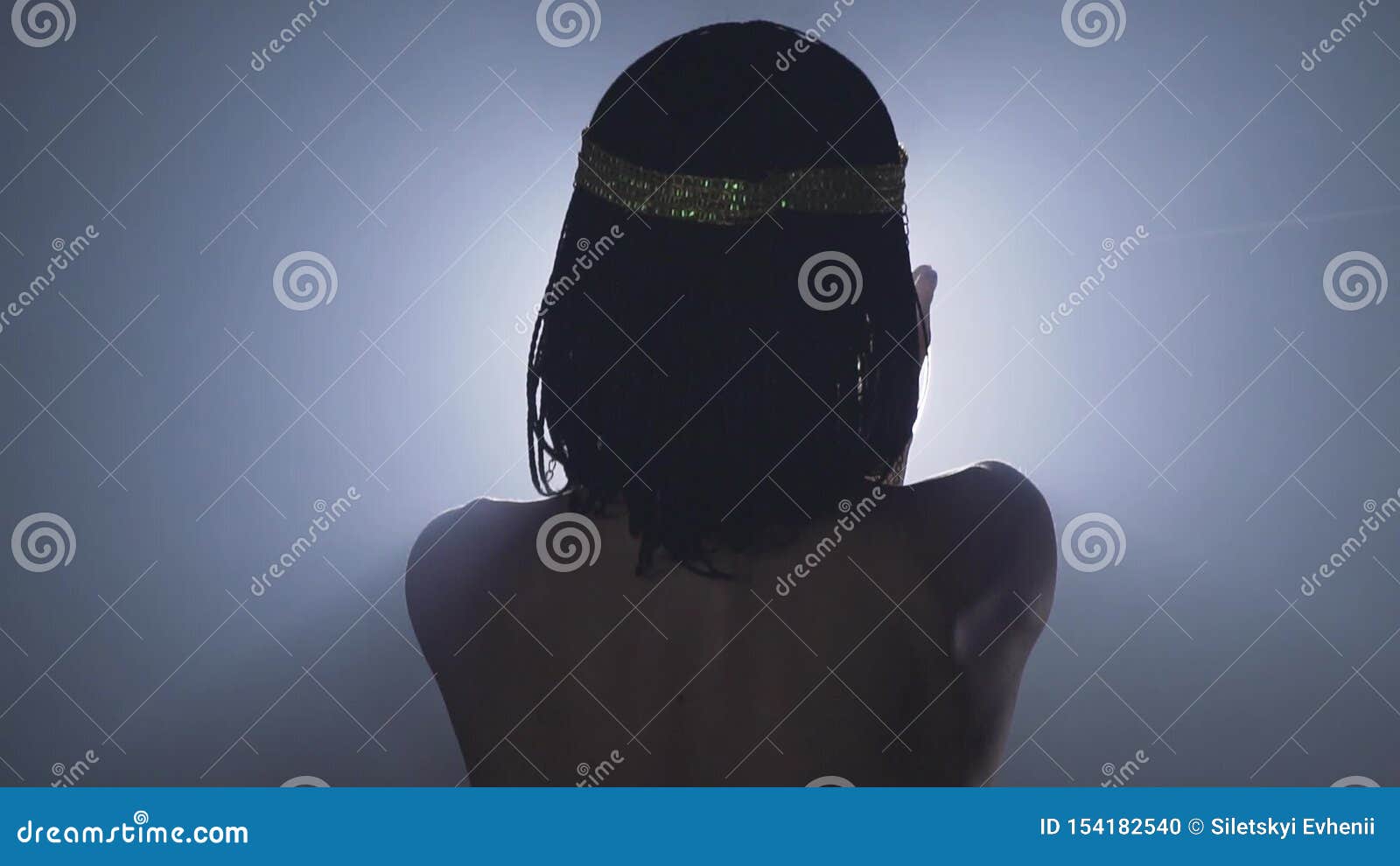 View from the Back on Young Cleopatra Dancing in from of the Light ...