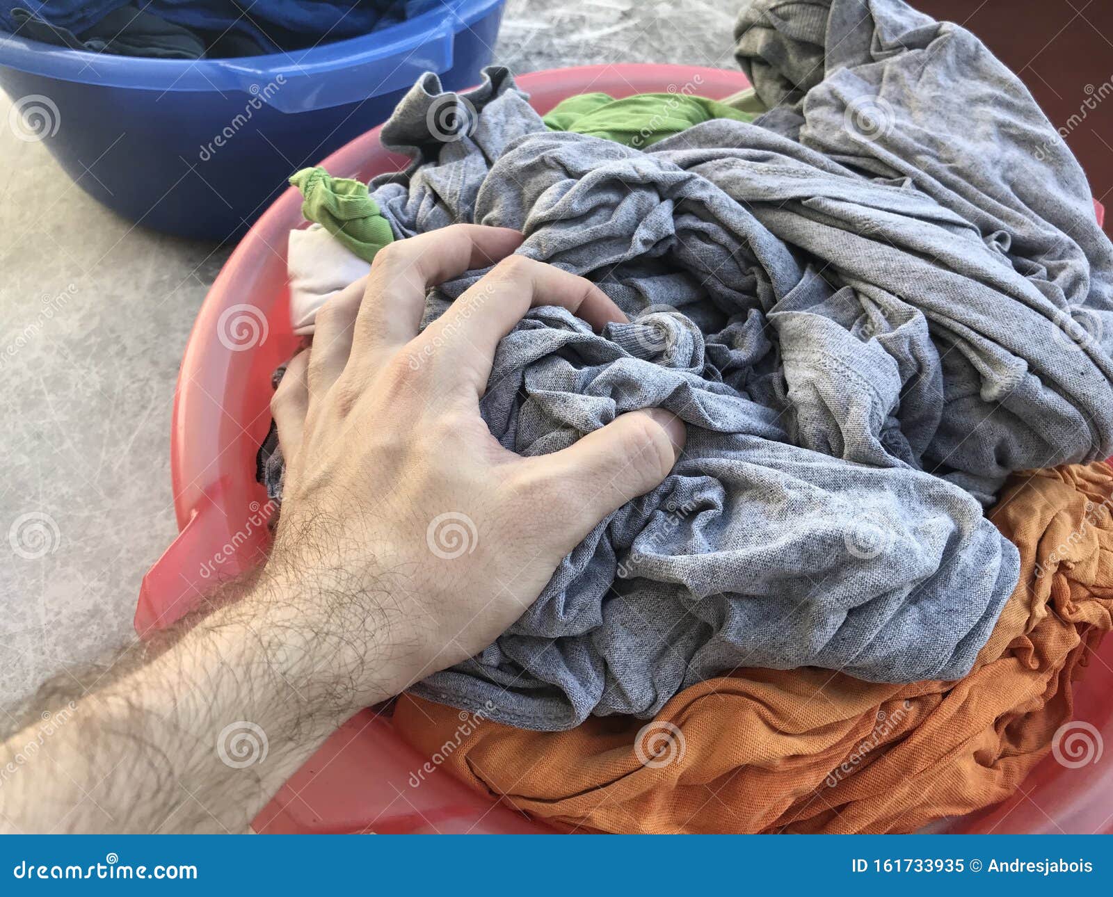 Basket Full of Clean Laundry with a Hand Picking Some Clothes Stock ...