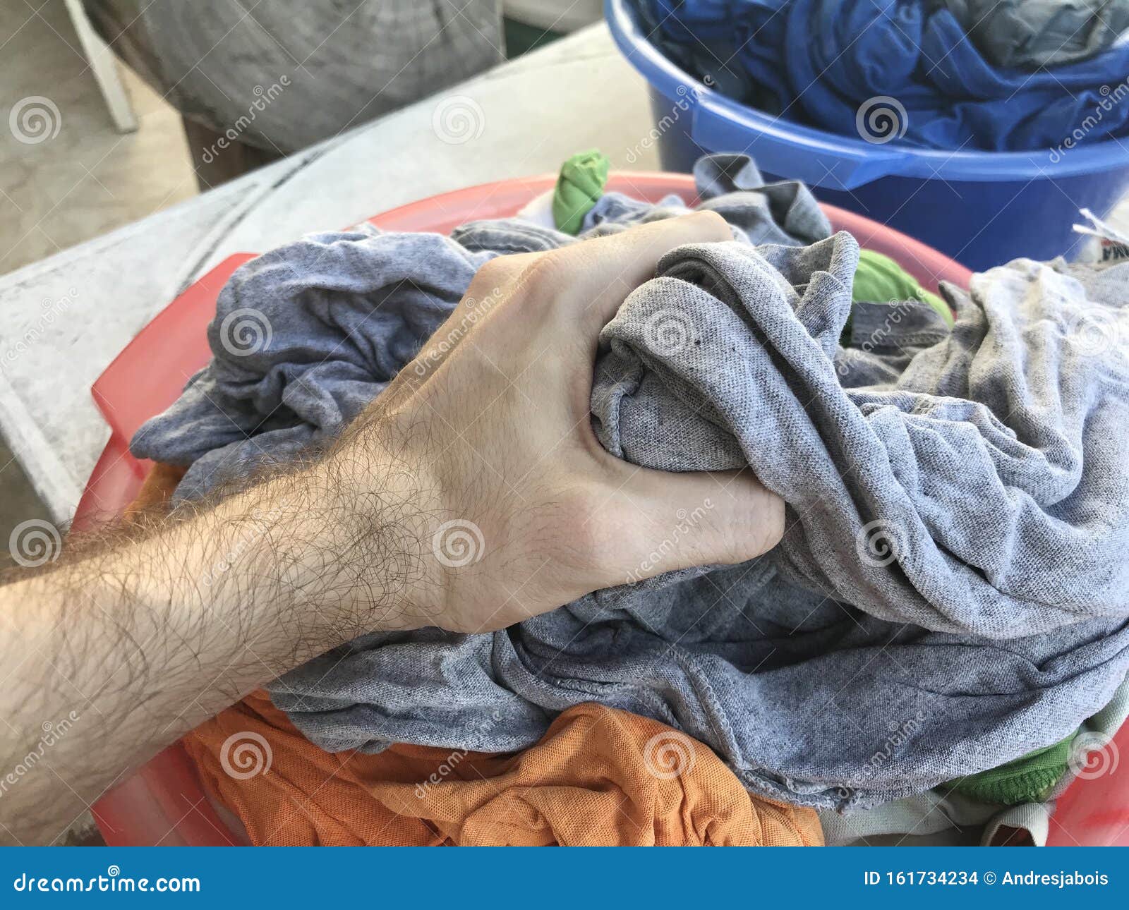 Basket Full of Clean Laundry with a Hand Picking Some Clothes Stock ...