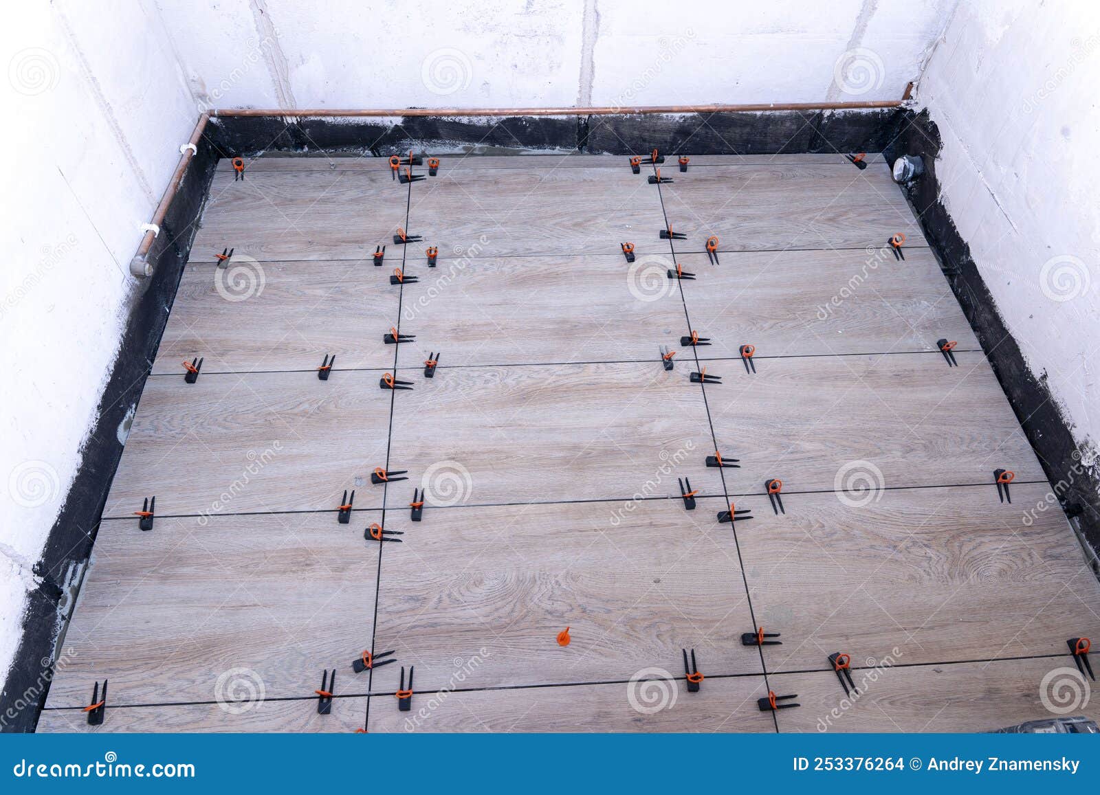 Close-up of the Tile Alignment System Holding Tile in Given Position ...