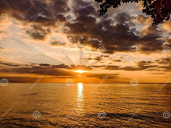 A View on the Beach with the Sun Coming Out Stock Photo - Image of ...